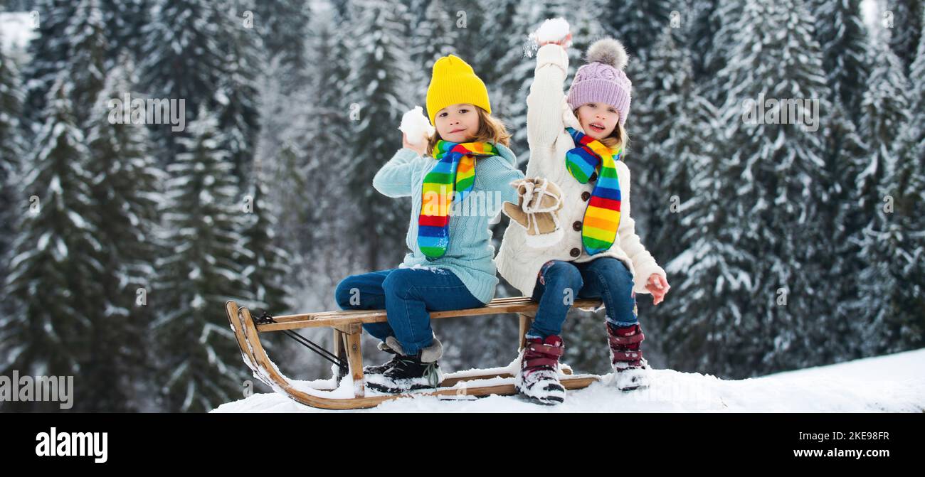 Kids play snowball, snow ball fight for children. Happy little kids ...