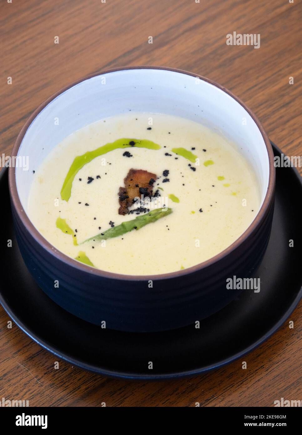 Traditional soup with creamy silky texture. Wood background. Copy space ...