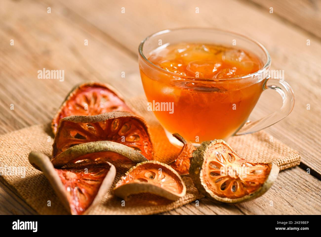 Bael tea on glass with dried bael slices on wooden background, Bael ...