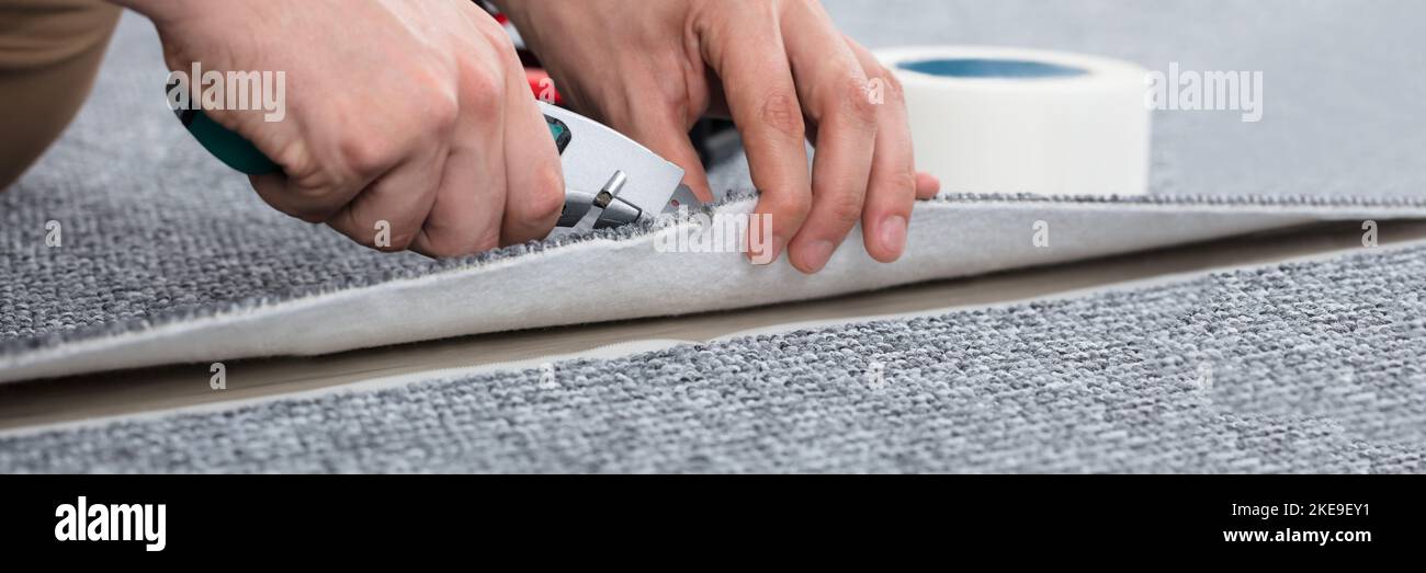 Floor Installation Worker Laying New Carpet At Home Stock Photo - Alamy