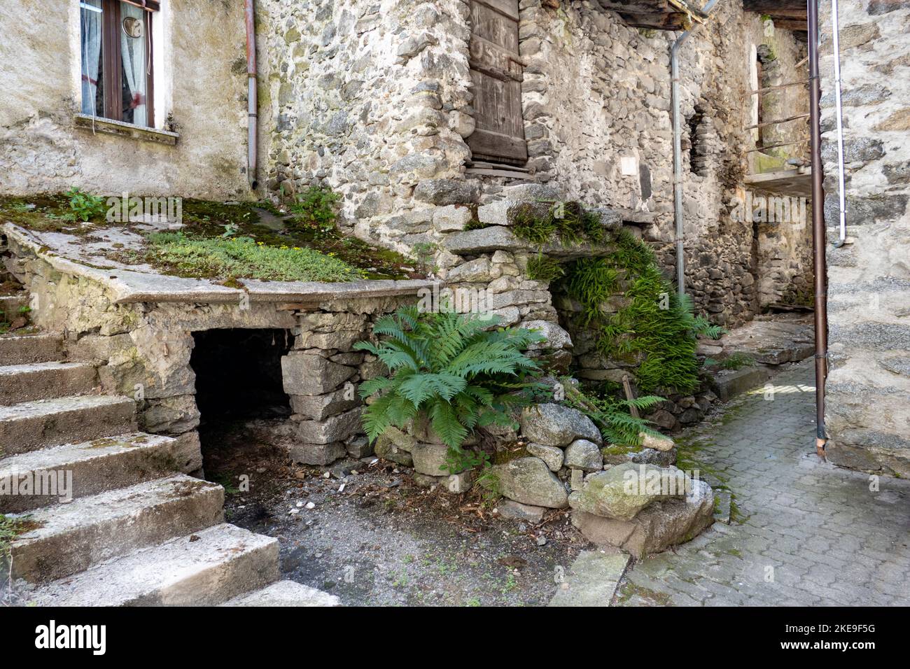 An old stone house with stairs and stones in front Stock Photo - Alamy