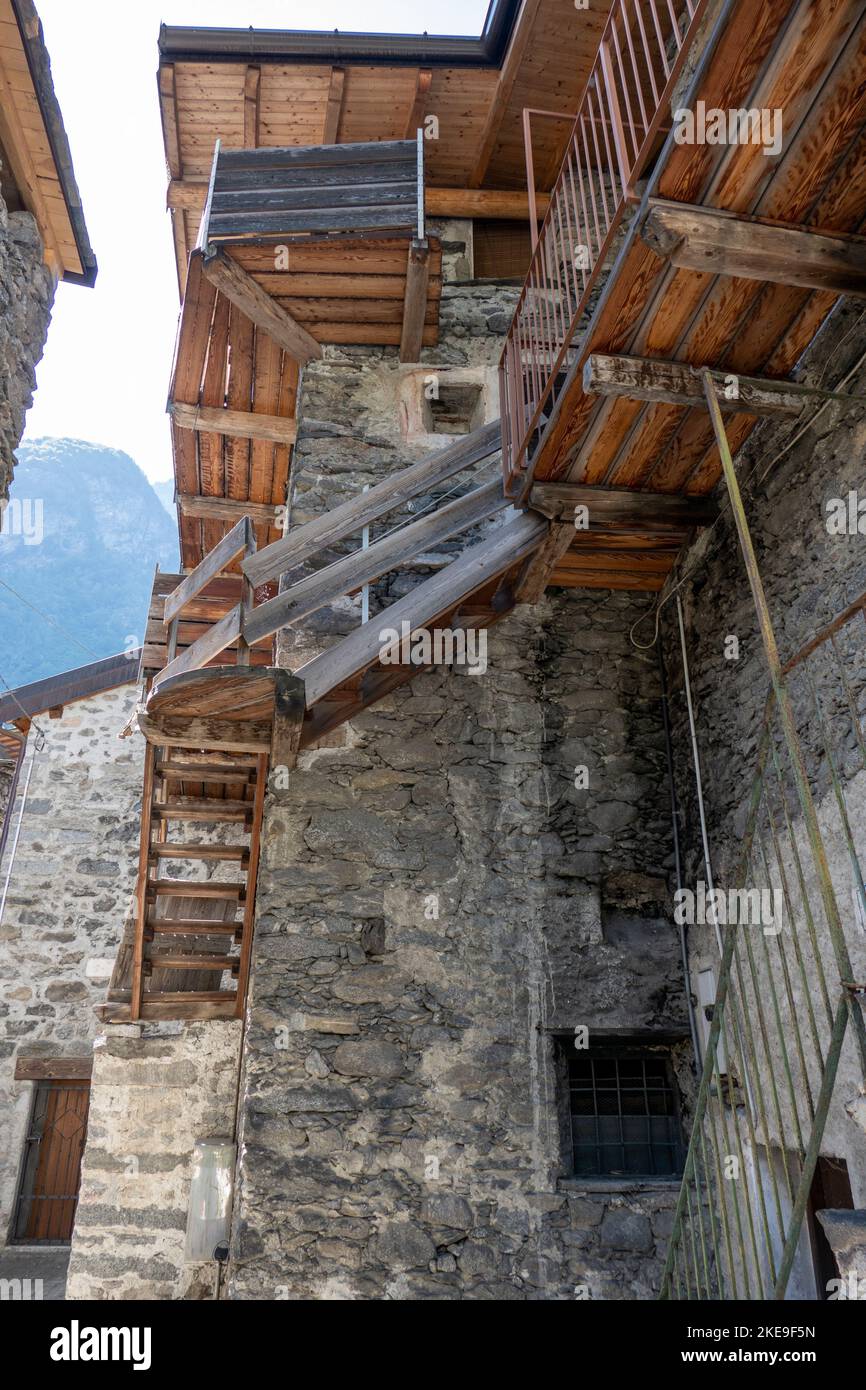 A low-angle shot of the old stony house with wooden staircase Stock ...