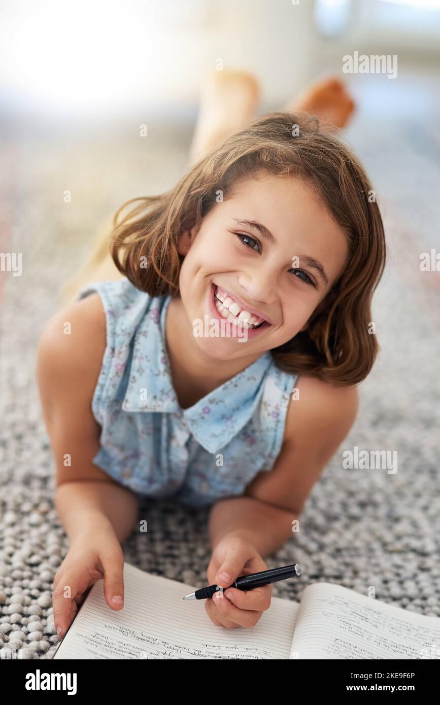 My teacher said Im an A student. Portrait of a young girl writing in a ...