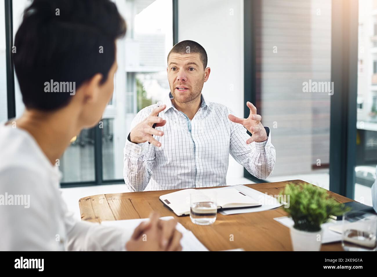 Putting his idea into perspective. a businessman gesturing while ...