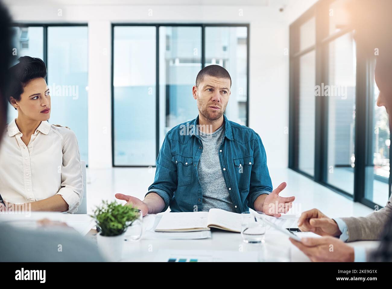 Making a point for his plan. a businessman gesturing while talking with ...