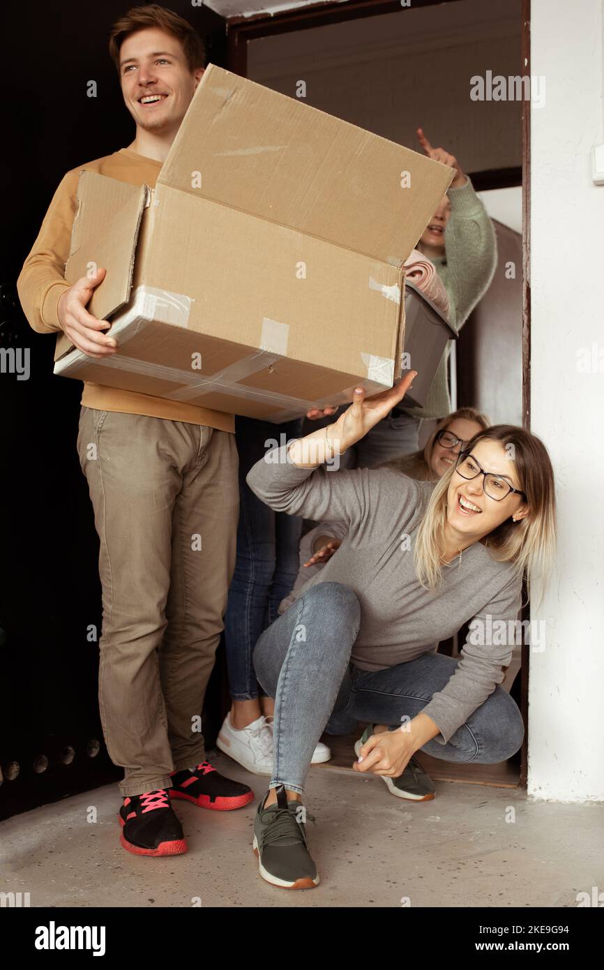 Vertical smiling joyful communicative teenage students taking out ...