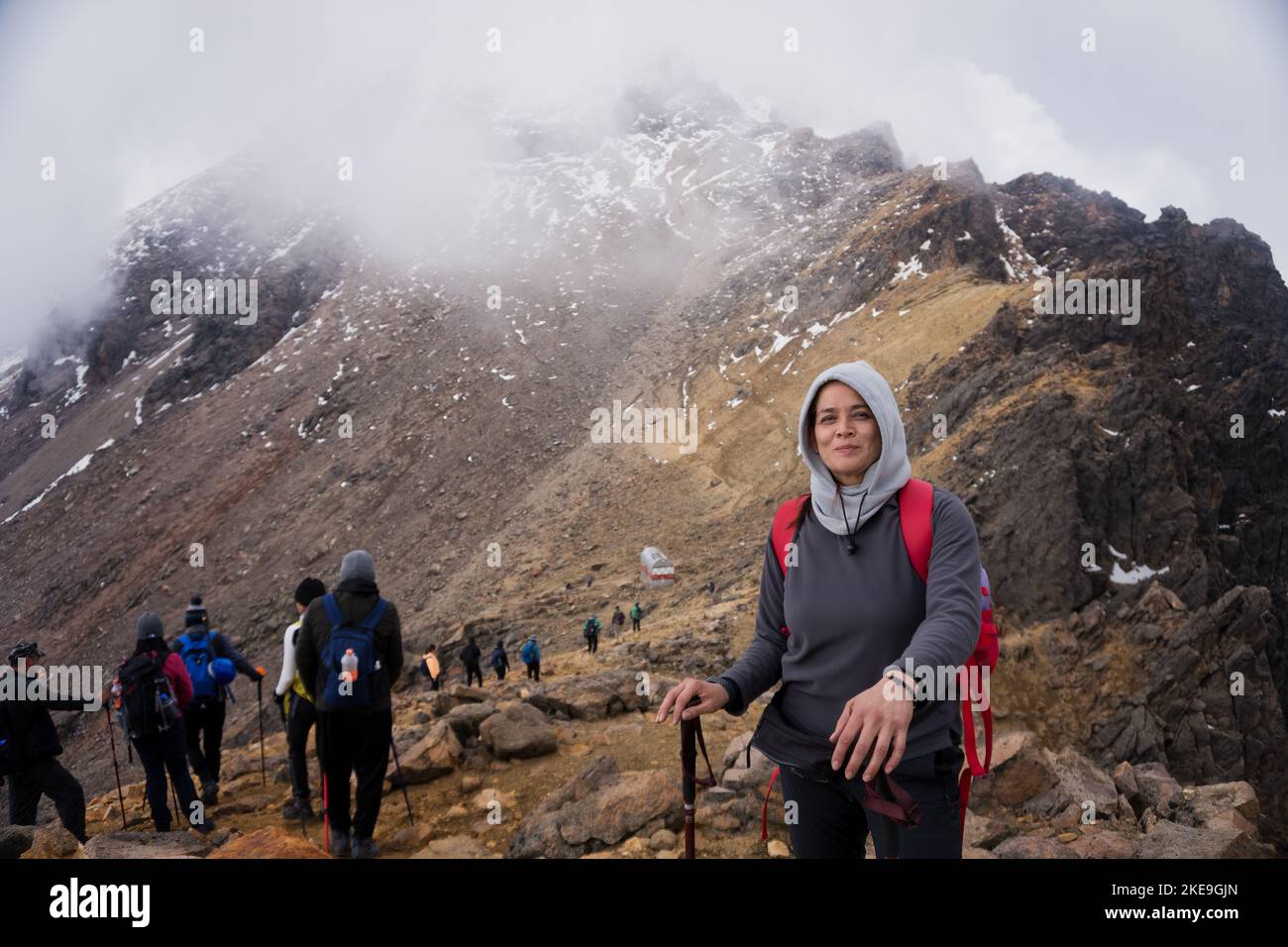 A Hispanic female hiking on top of Iztaccihuatl volcano with a group on ...