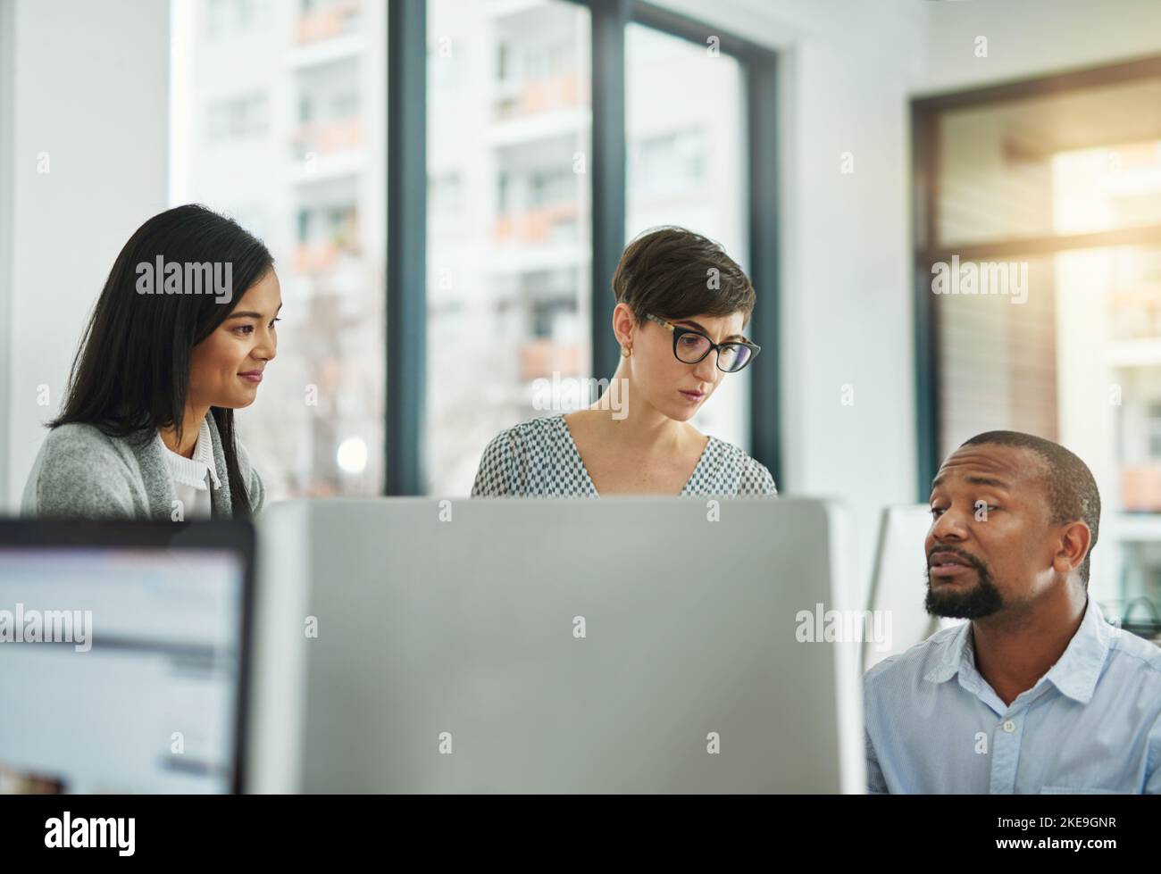 Lets talk it over. a group of colleagues working in their office Stock ...