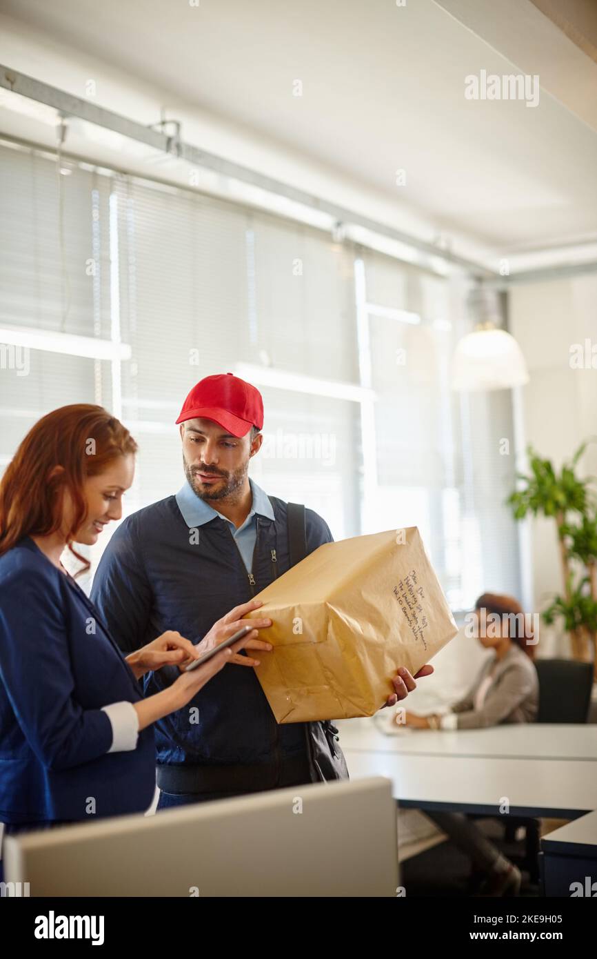 They deliver to offices too. a young woman receiving a package from a ...