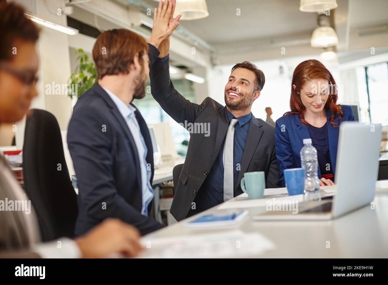 Winners win with teamwork. colleagues giving each other a high five ...