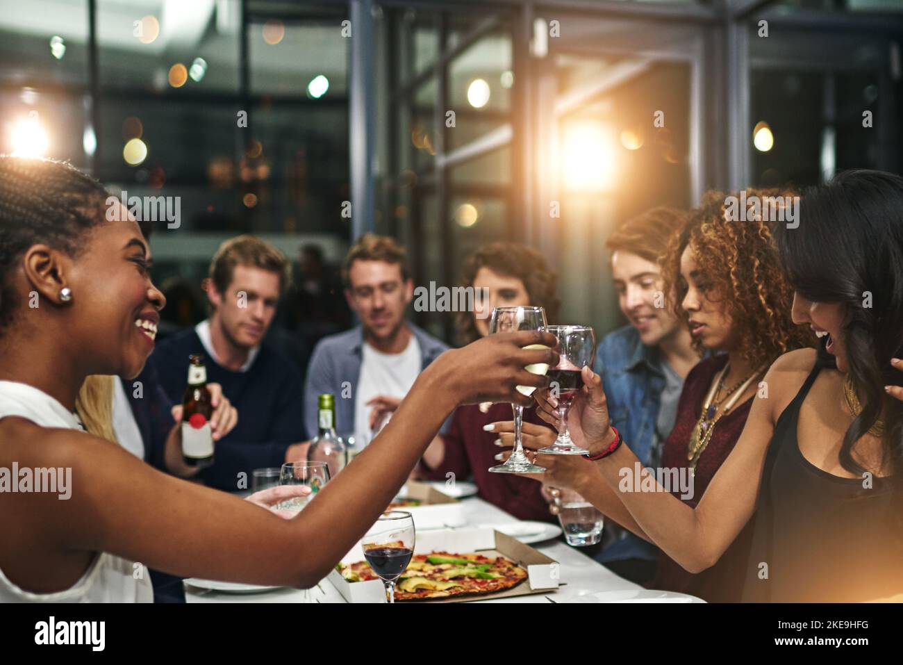 Good food, good friends, good times. friends having a dinner party at a ...