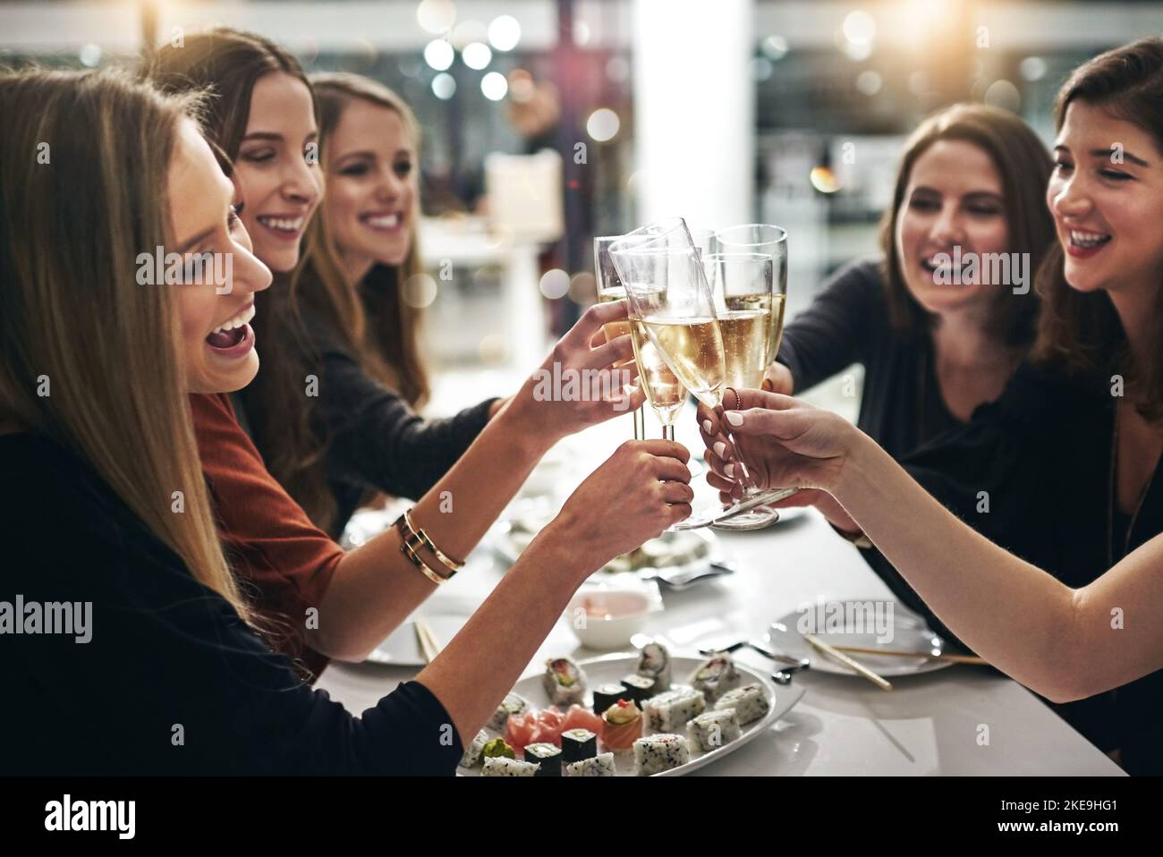 Toasting their friendship. a group of young girlfriends toasting during ...