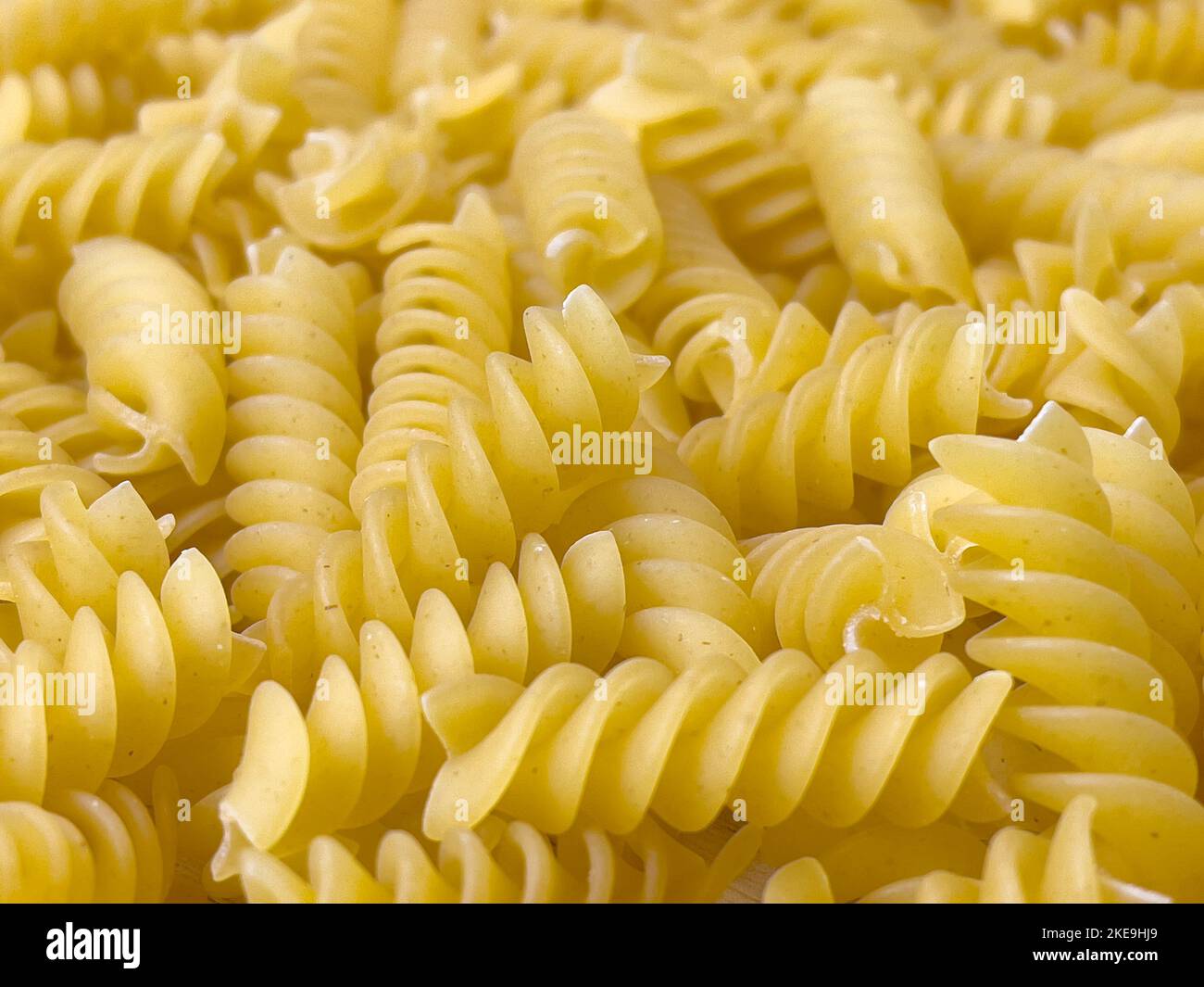 Food background or texture raw dry Italian pasta in shape of spiral ...