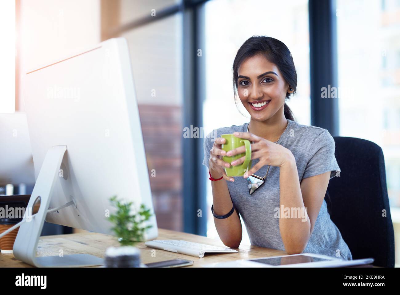 Taking a brief timeout with a cuppa joe. Portrait of a happy young ...