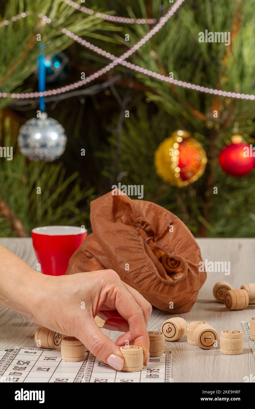 Woman's hand holding a wooden barrel for a game in lotto Stock Photo ...