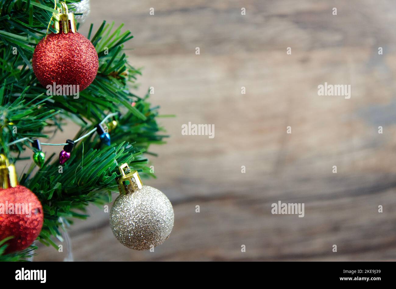 Macro Christmas baubles on tree with wooden background Stock Photo - Alamy