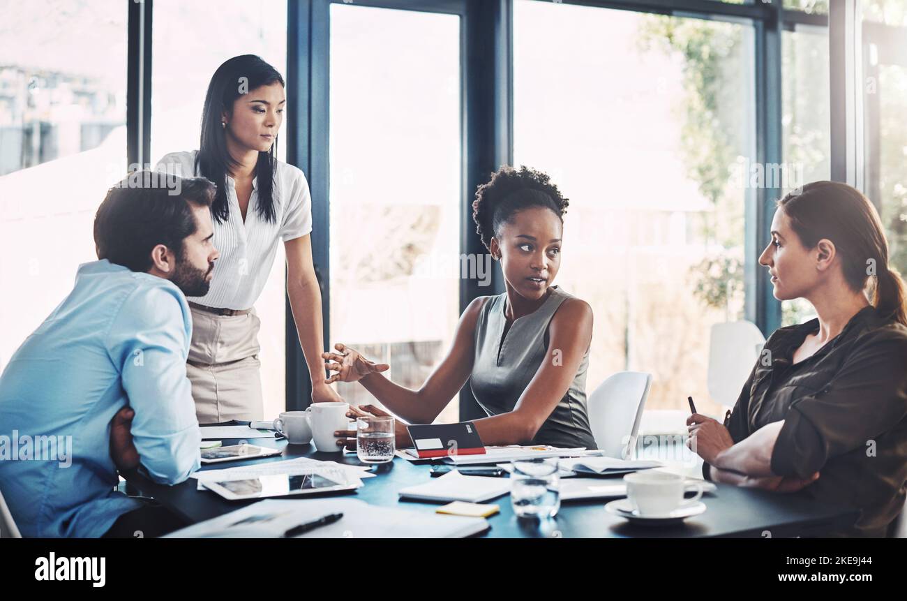 Making suggestions to her team. a group of diverse businesspeople ...