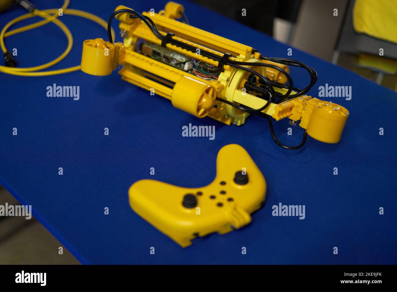 Programmable yellow aquarobot for children's robotics classes on a blue ...