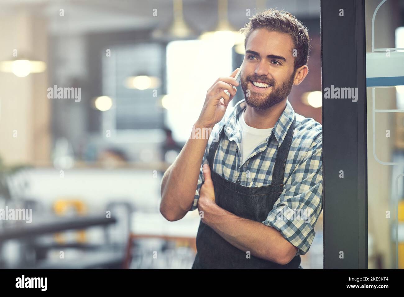 Employee turned entrepreneur. a young man using a phone in the store ...