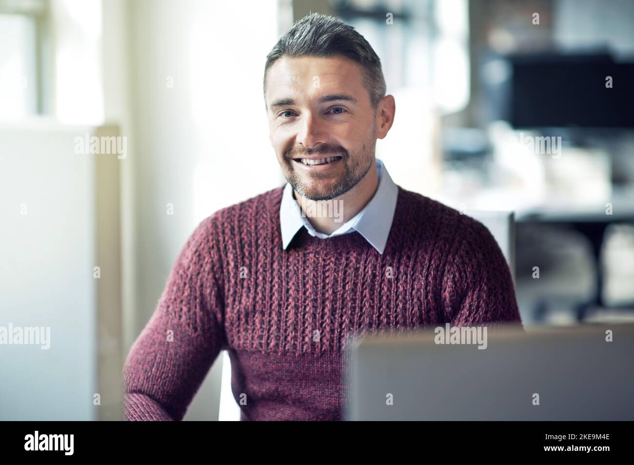 I believe that a smile can take you places. a businessman working on ...