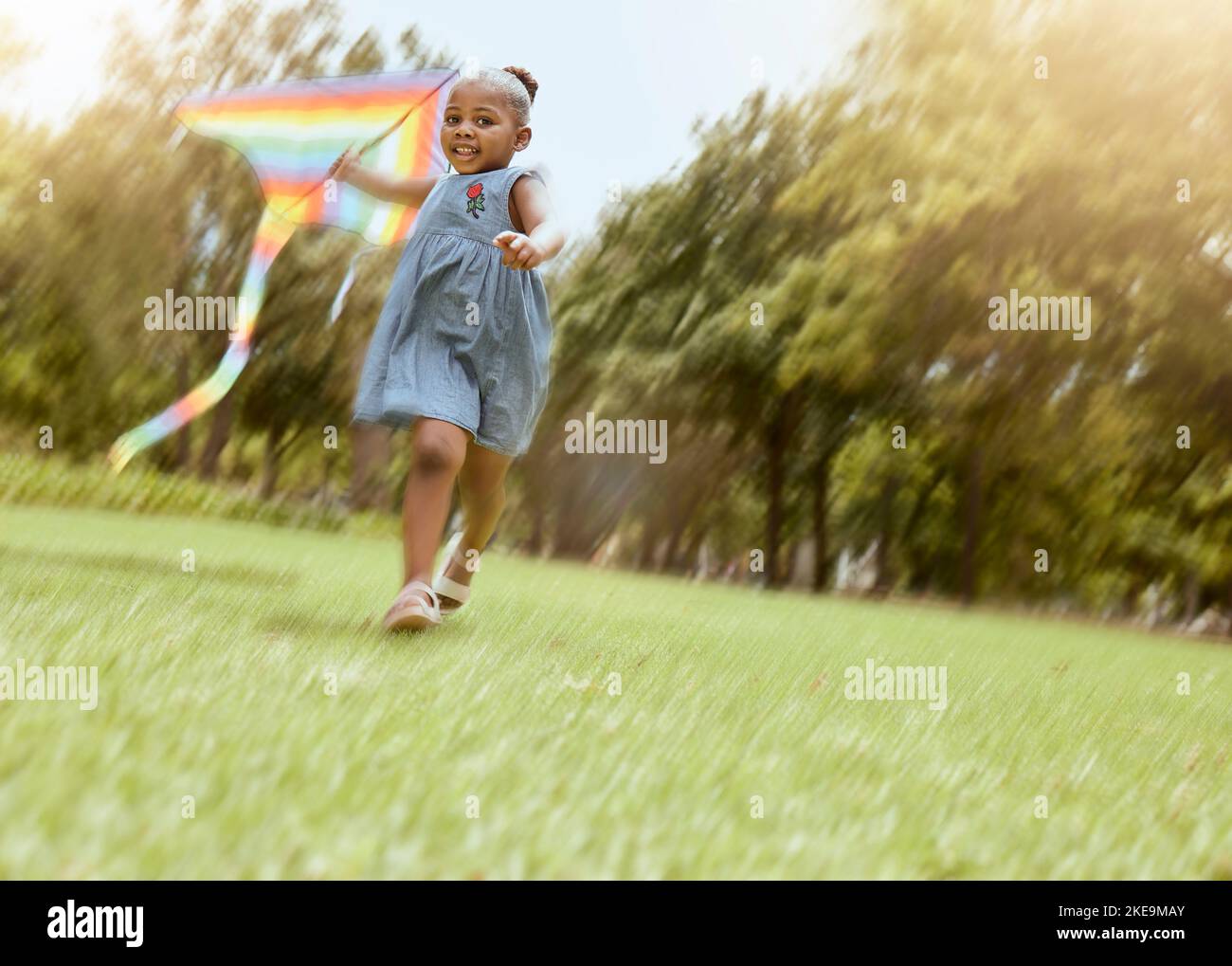 Girl, running with kite and nature park for happy, fun outdoor activity ...