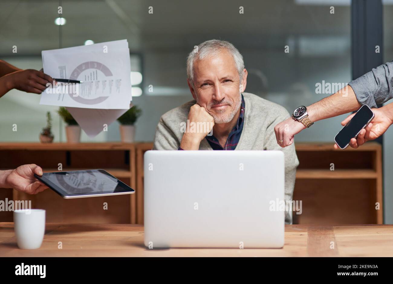 All in a days work. Portrait of a smiling businessman surrounded by ...