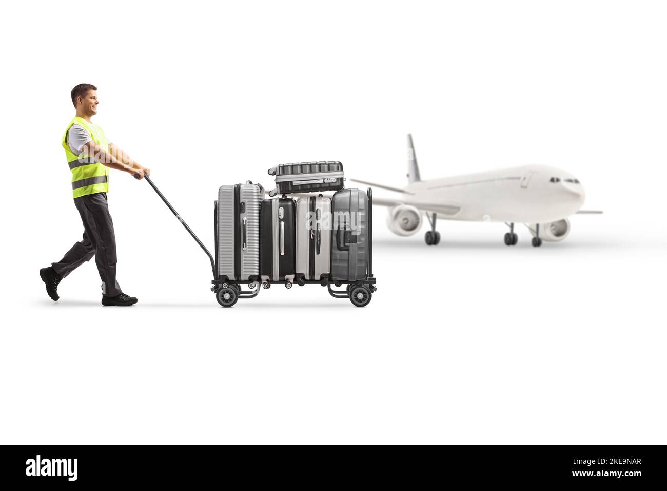 Airport worker pushing a luggage cart with suitcases toards an airplane ...