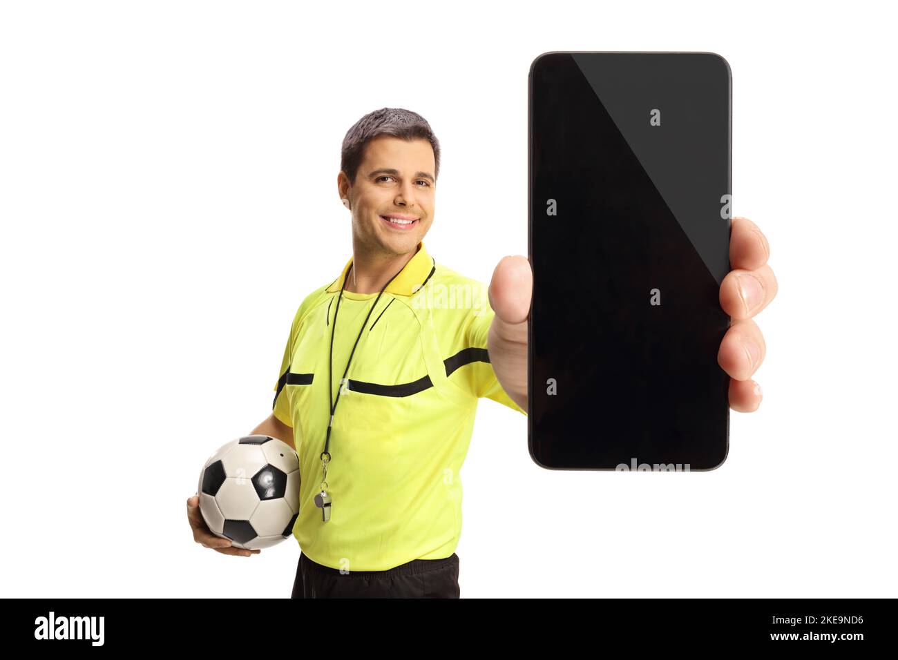 Football referee holding a ball and showing a smartphone isolated on ...