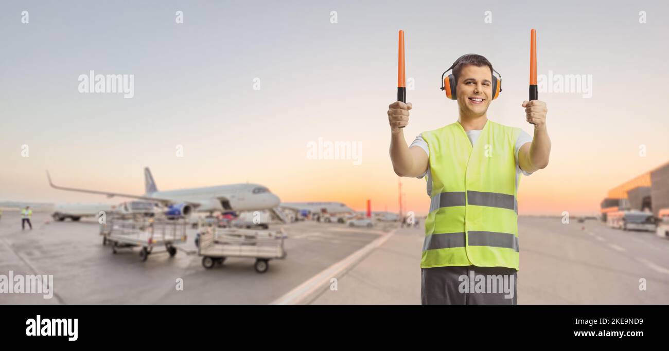 Aircraft marshaller signaling with wands at an airport apron Stock ...