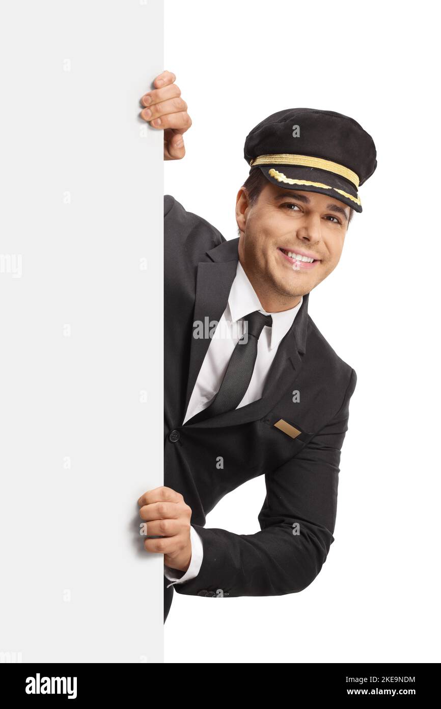 Smiling bellboy standing behind a white panel isolated on white ...