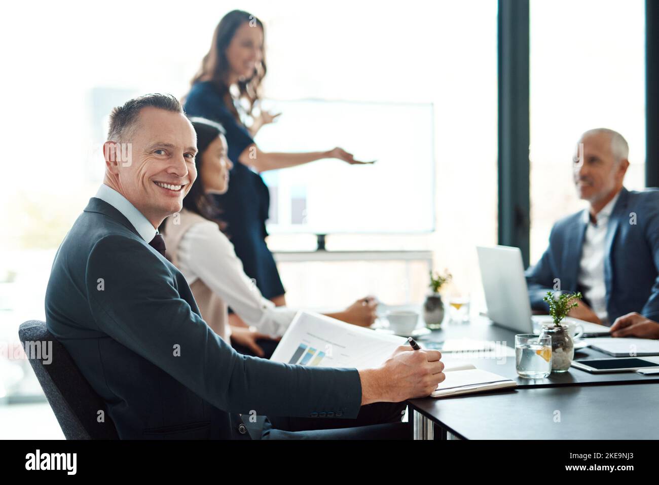 Shes doing an excellent job. Portrait of a businessman sitting in a ...