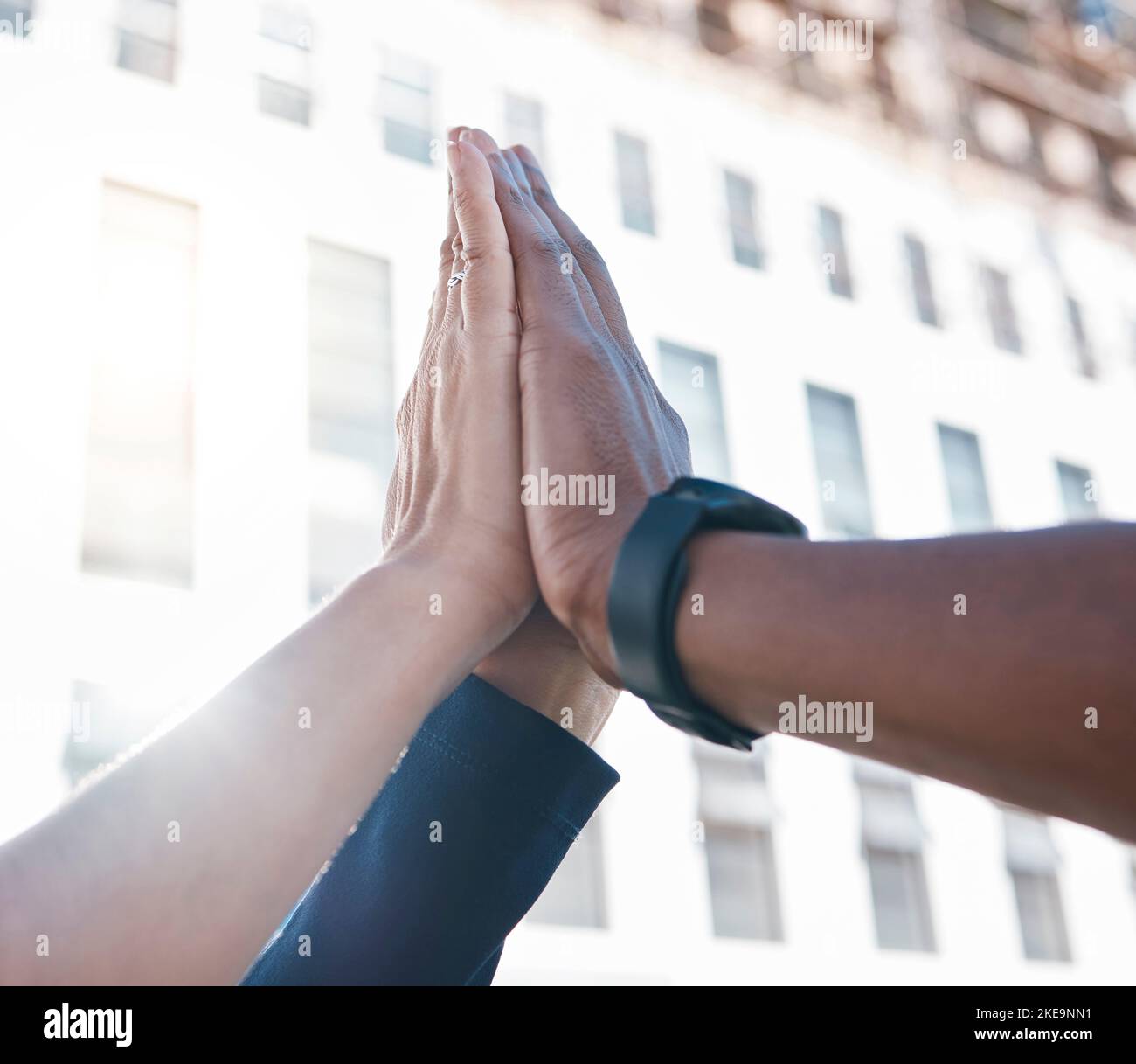 Business people, hands and high five in city for success, community ...