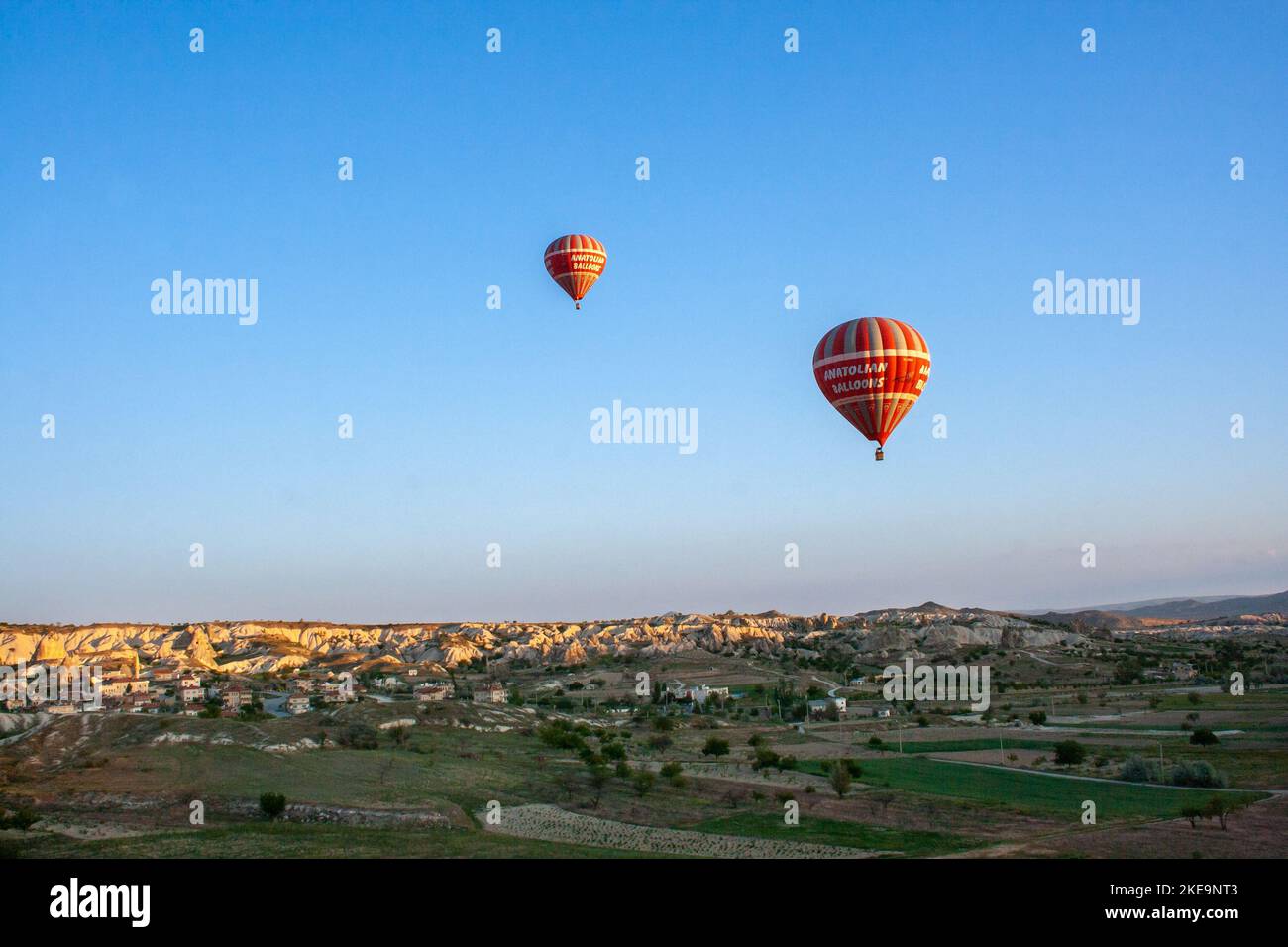 hot air balloons rise over the chimneys rock formation, Cappadocia ...