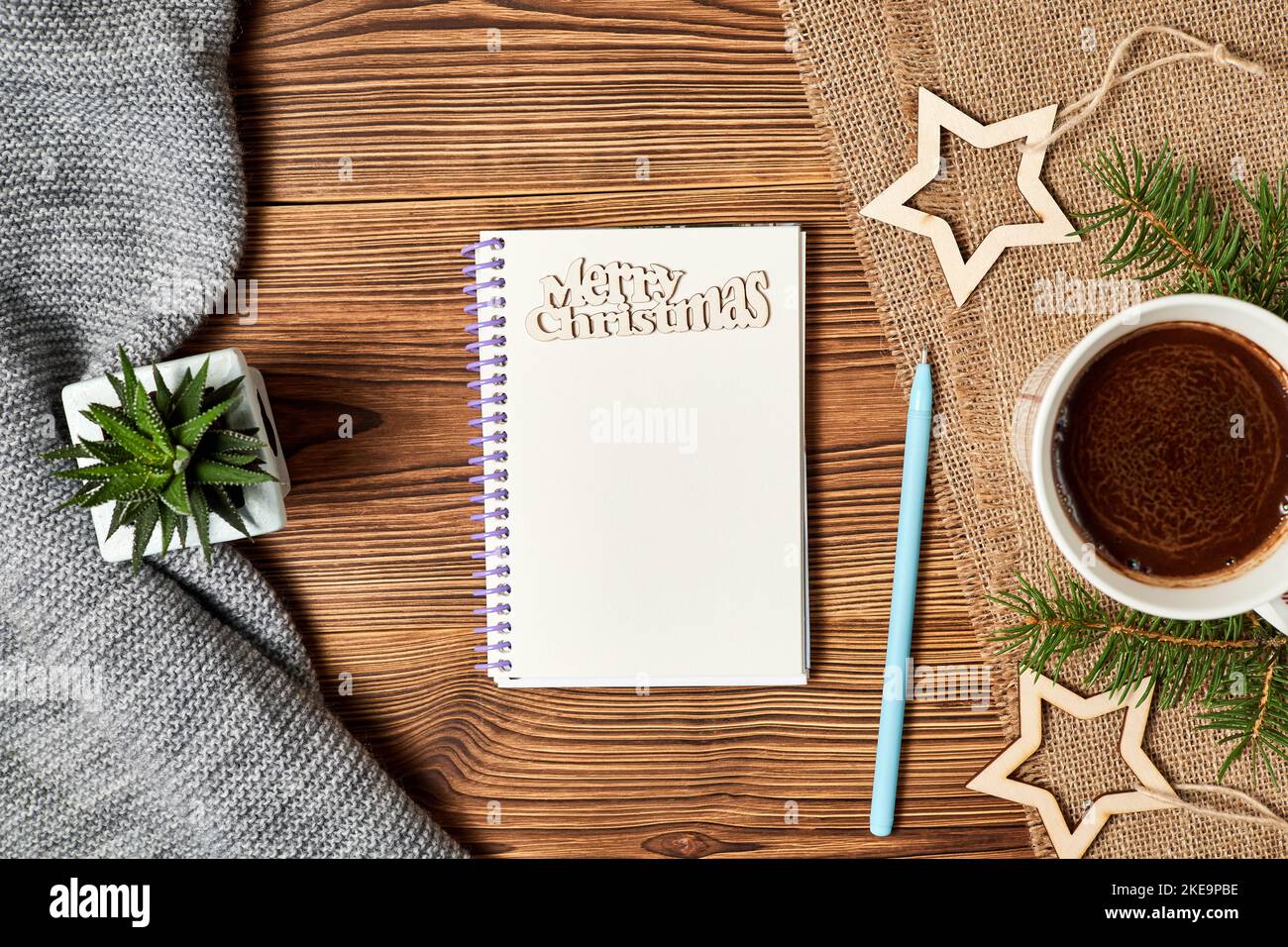 Christmas composition of open blank notepad, coffee cup, scarf, Cactus ...