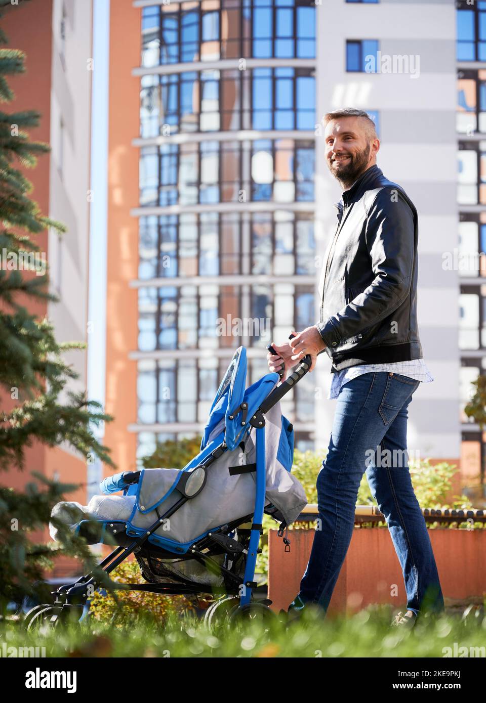 Father spending time with newborn kid outside. Young bearded man ...