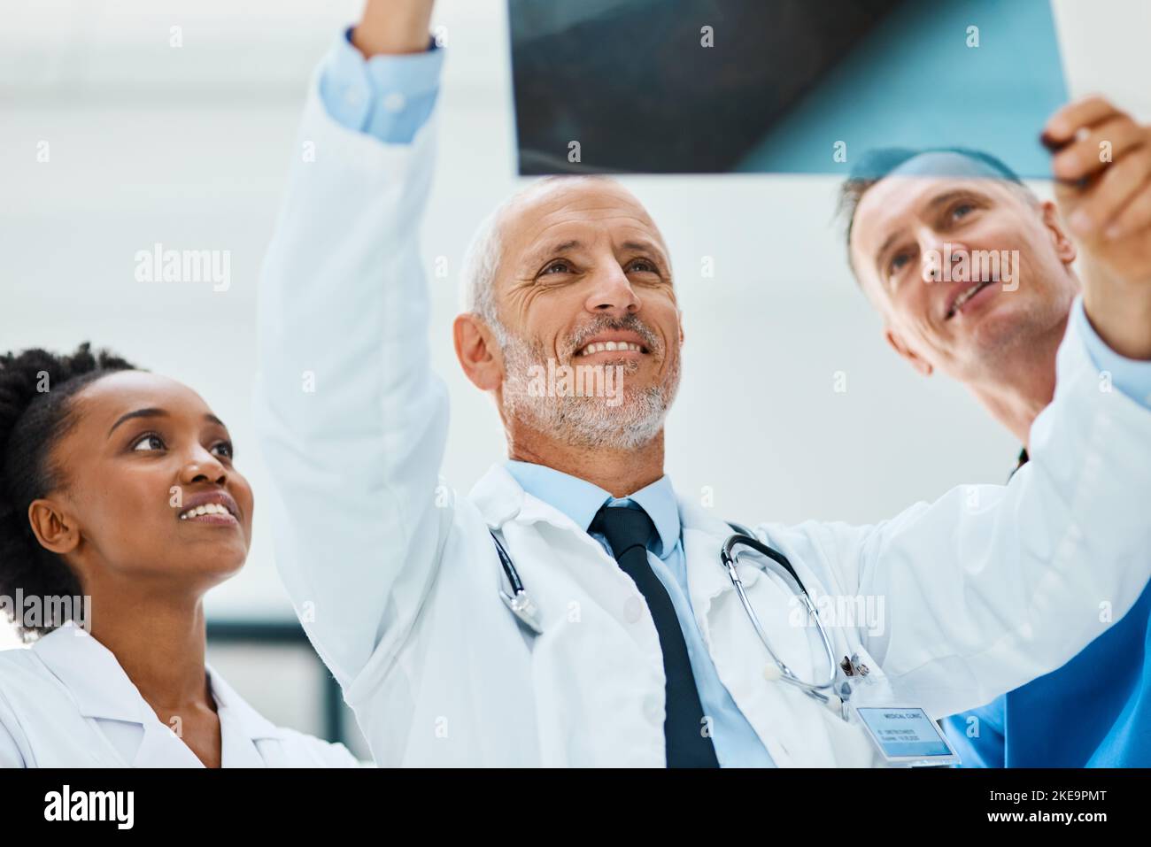 Its a good feeling helping others. medical practitioners looking at a ...