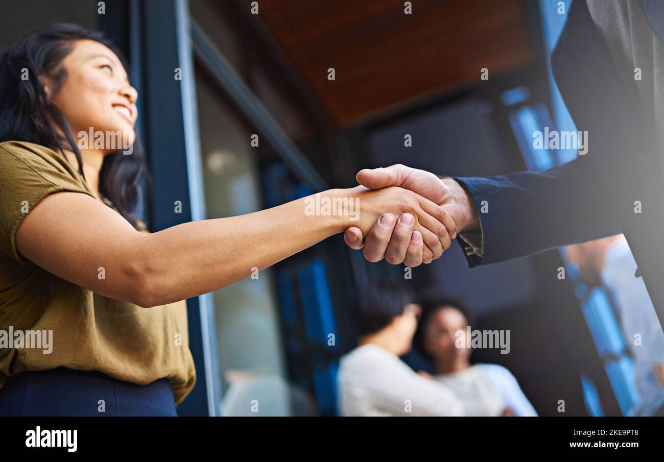 Im glad weve reached an agreement. two businesspeople shaking hands ...