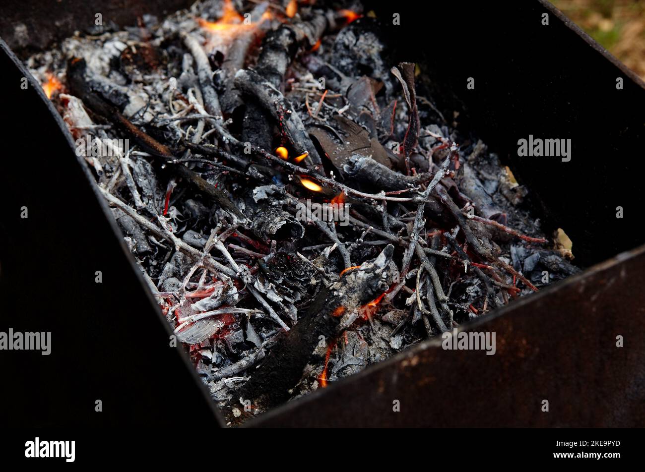 Burning red hot sparks fly from fire. Barbecue gril with glowing and ...