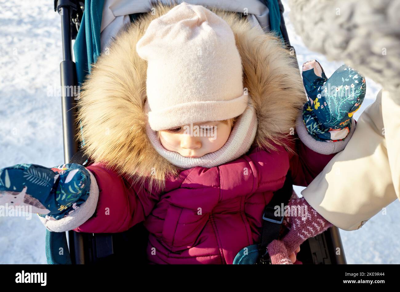Mother and daughter are walking in the winter city park on Christmas ...