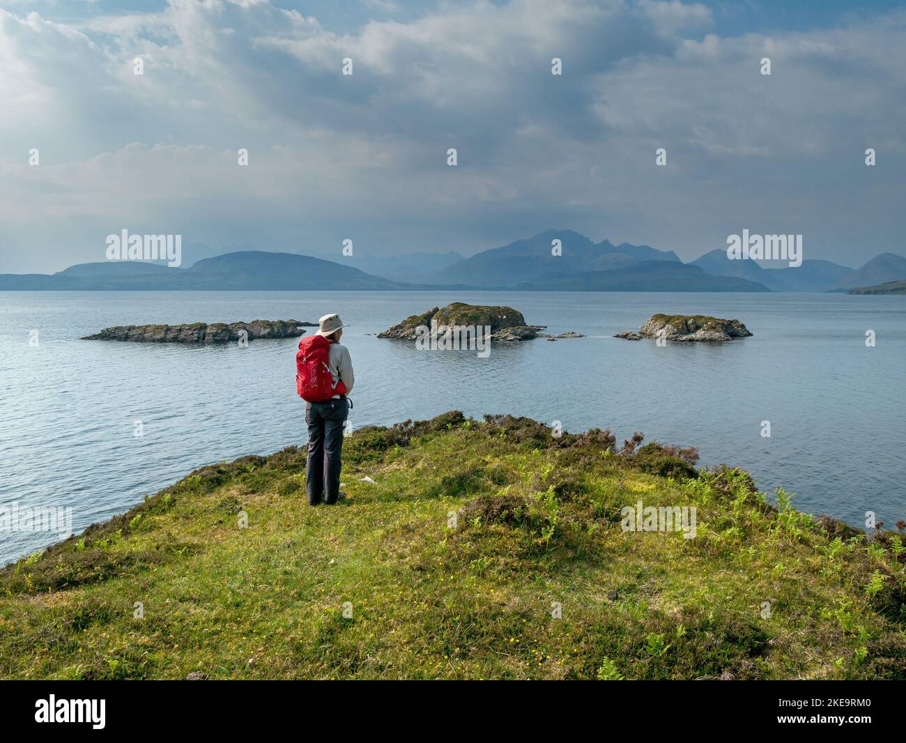 Tourist views the tiny islands of Eilean Ruairidh and Loch Eishort with ...
