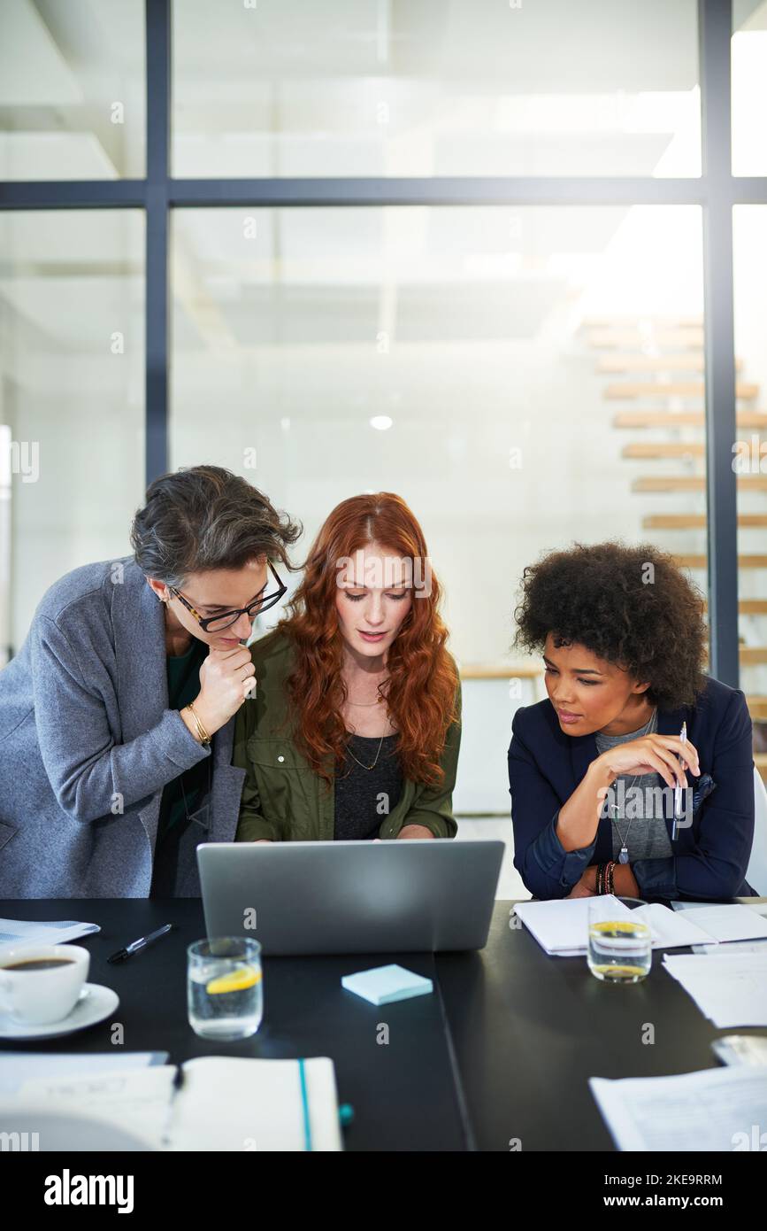 Getting everyone on the same page. three young creatives working ...