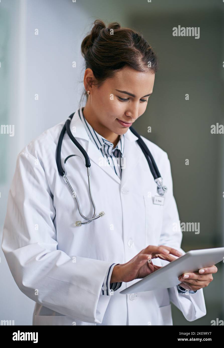 Making informed decisions about your health. a young doctor using a ...