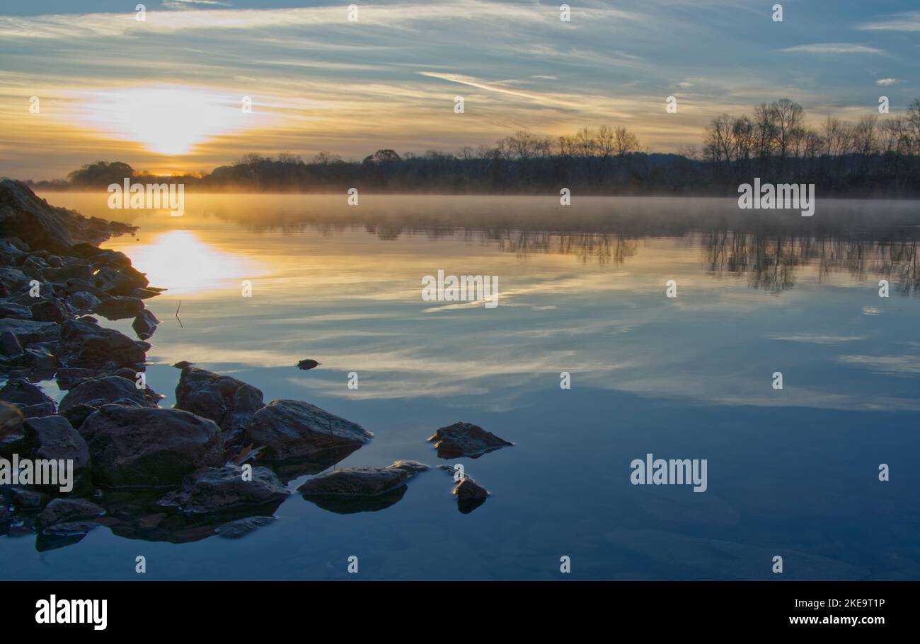 Sunrise over river with cirrus clouds and blue sky Stock Photo - Alamy