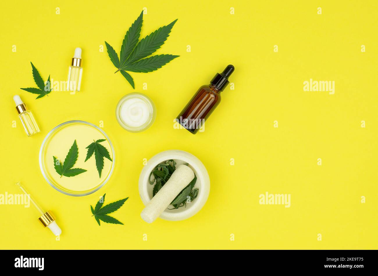 Natural hemp cosmetics. An open jar of body cream, a mortar and pestle ...