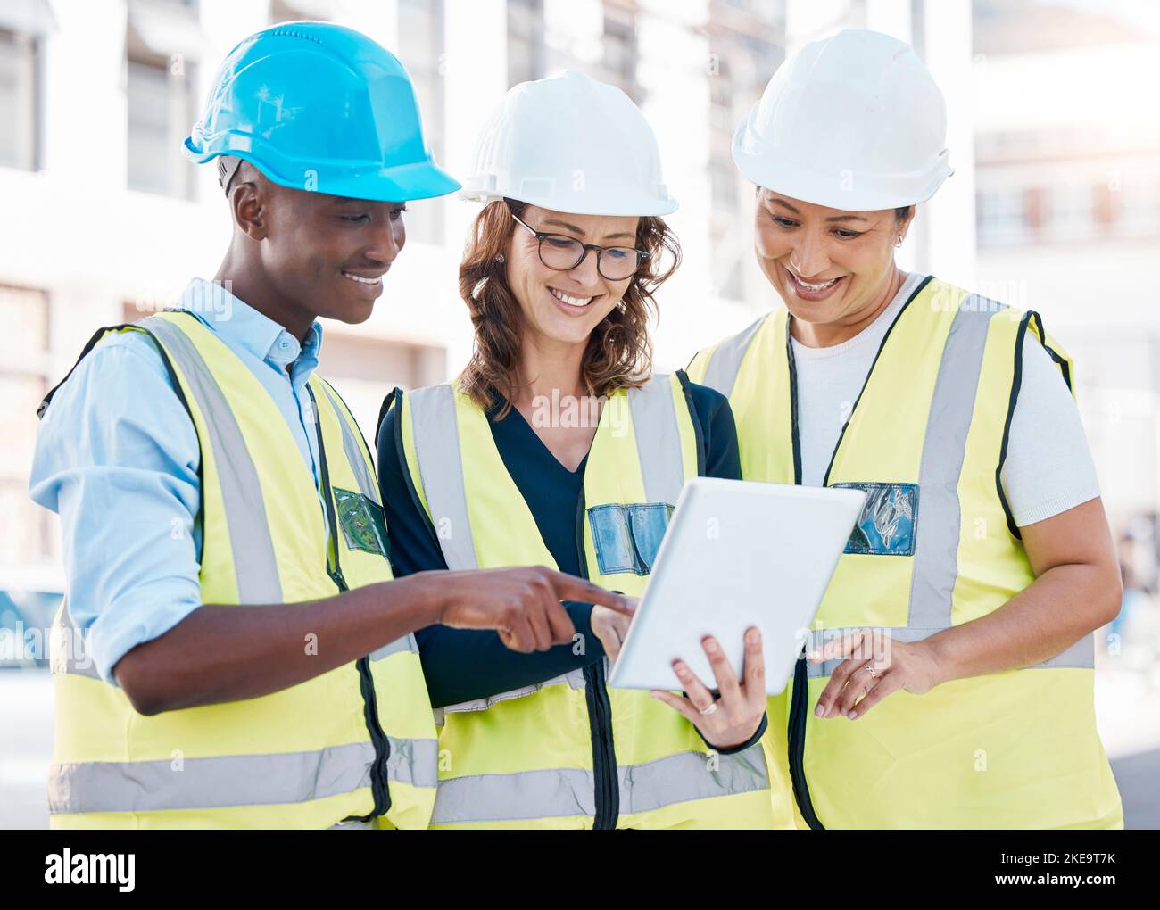 Construction, tablet and teamwork on a building project outdoor while ...
