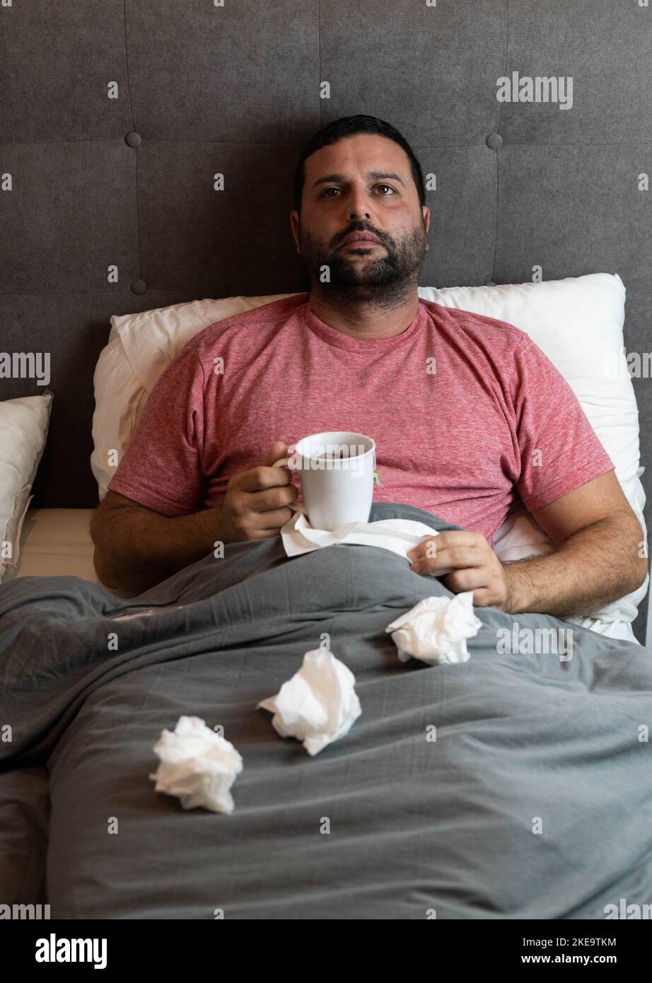 man in bed sick with coronavirus drinking a cup of tea Stock Photo - Alamy
