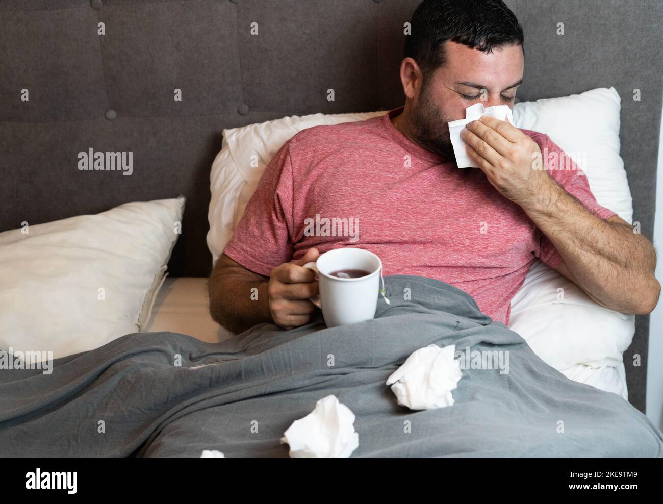 man in bed sick with coronavirus drinking a cup of tea Stock Photo - Alamy