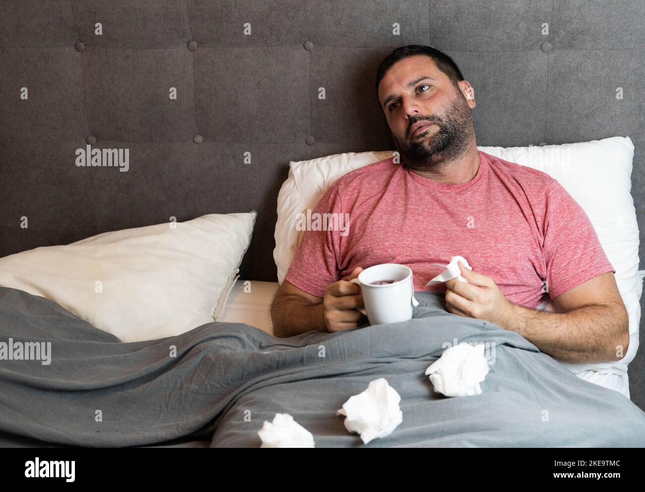 man in bed sick with coronavirus drinking a cup of tea Stock Photo - Alamy