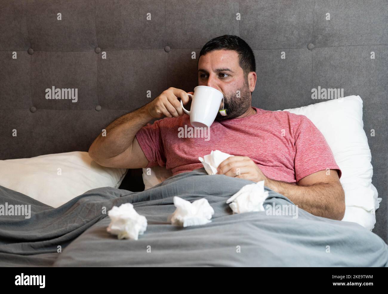 man in bed sick with coronavirus drinking a cup of tea Stock Photo - Alamy