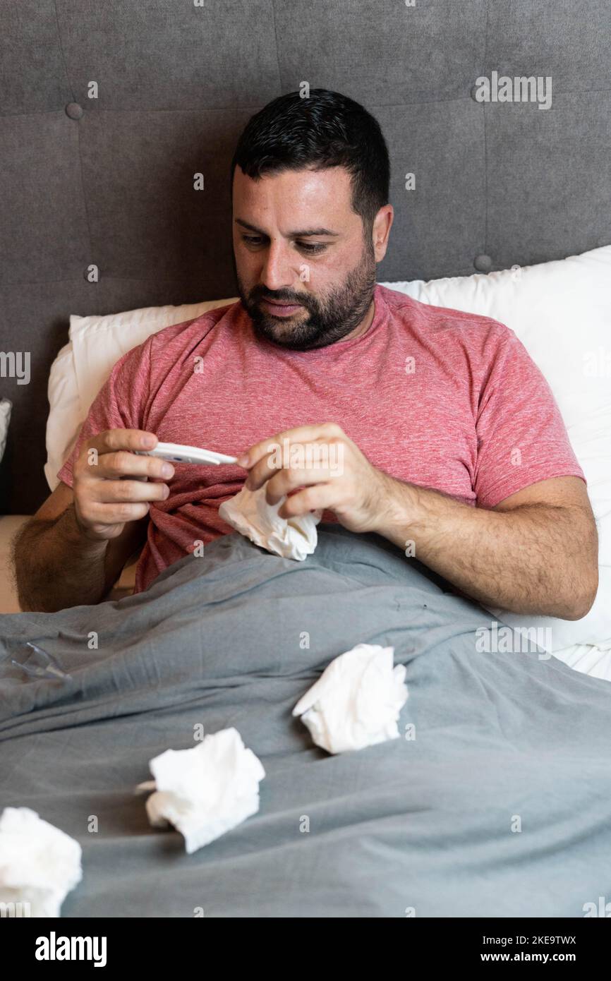 man in bed sick with coronavirus drinking a cup of tea Stock Photo - Alamy